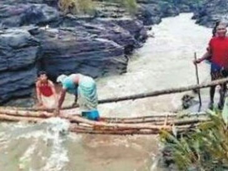 People come and go by making a temporary wooden bridge in the tribal ...