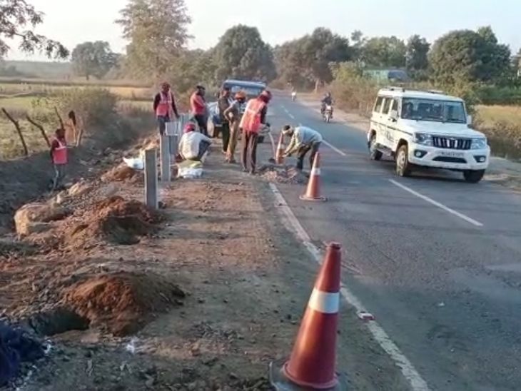 Cross barrier, reflector light and stone pillar are being installed in ...