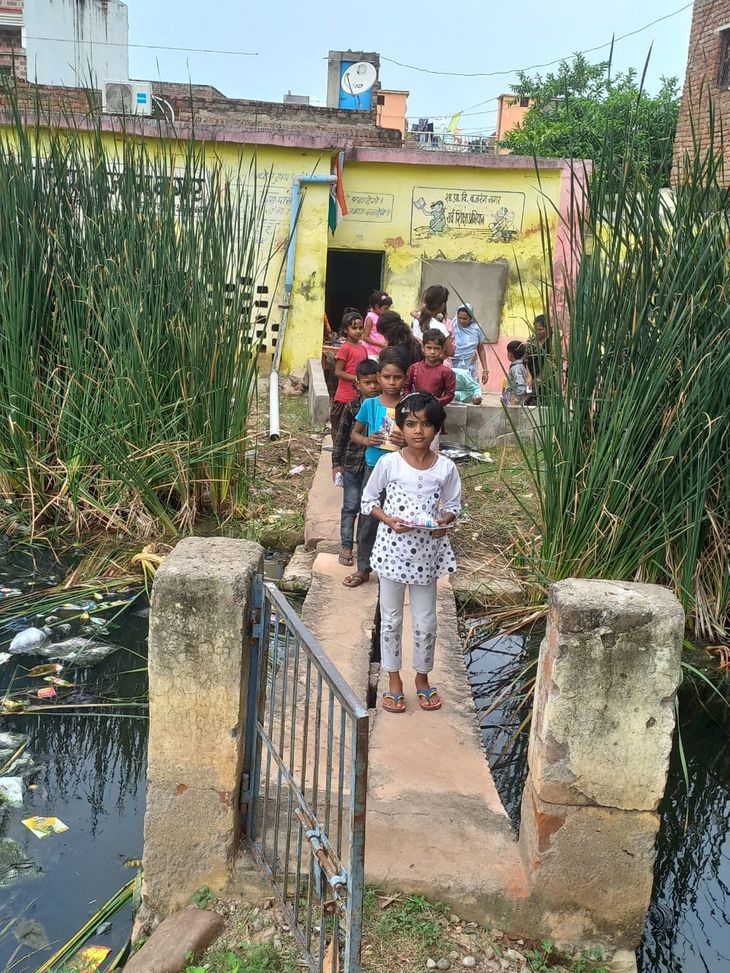School children coming out of the slab placed over the drain, parents ...