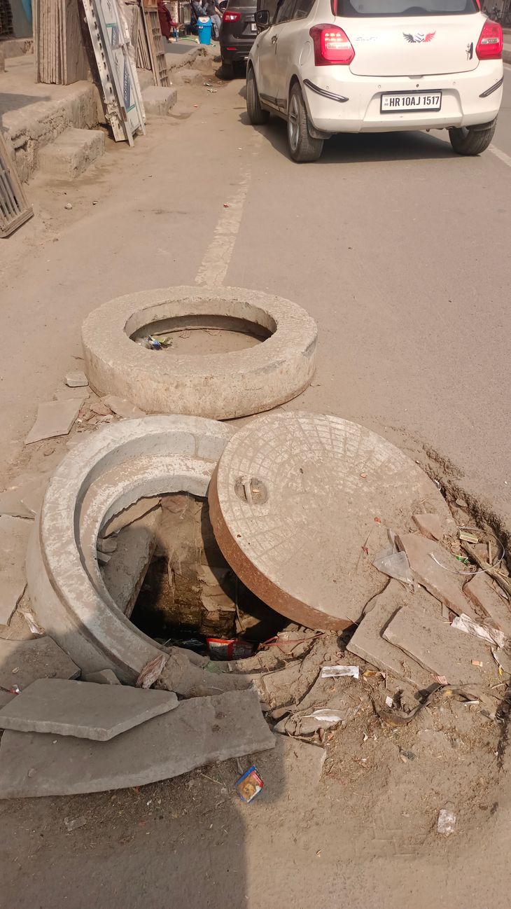 People symbolically placed stones and bamboo on open manholes in the ...