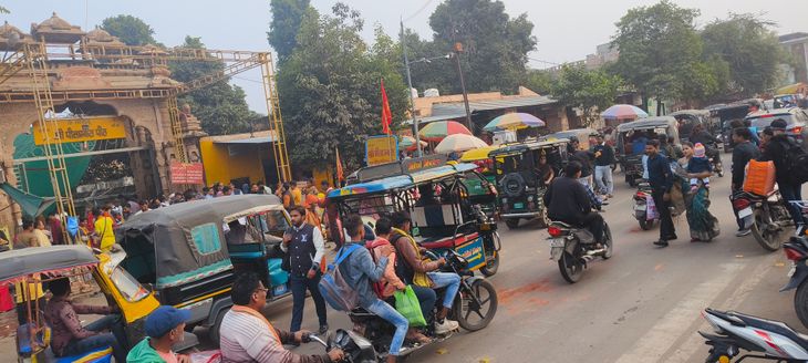 Autos are parked on the road in front of Pitambara Peeth, causing ...