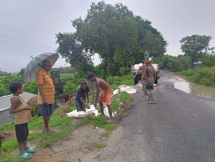 The pit created on the embankment due to rain cut is being repaired by ...