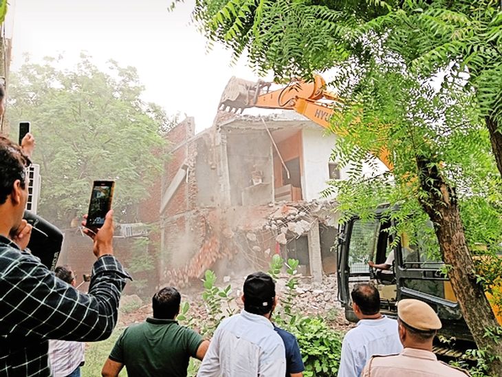 A two-storey building built on government land was demolished on the ...