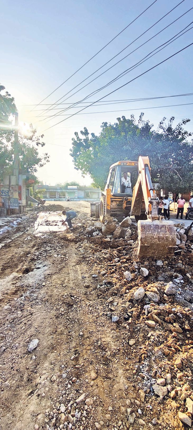 Work on 7 meter wide and 1 feet high CC road from under bridge to ...