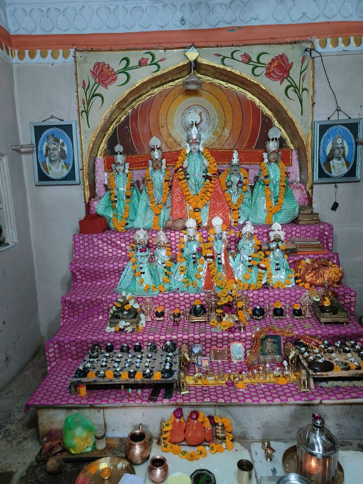 Raja Raghunath Ji is seated with his family in peacock feather attire ...