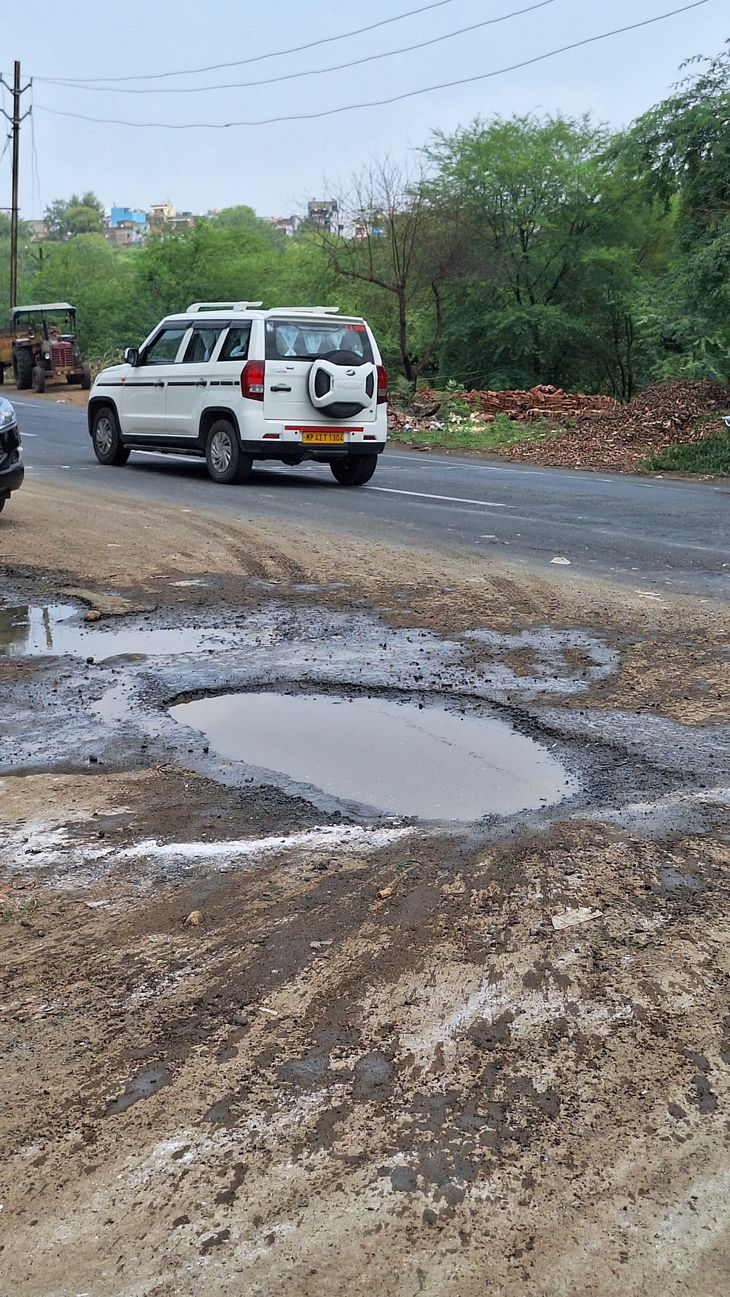 Accident due to big pothole on the side of highway, problem of bad road ...