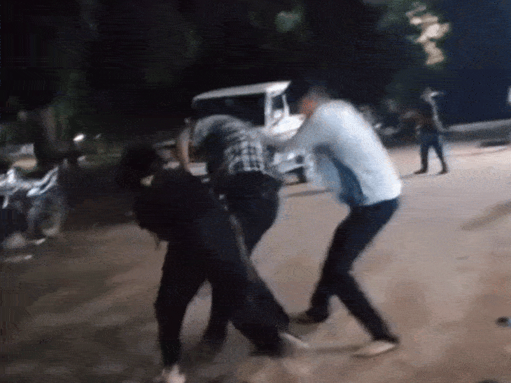 A video of a fight between four people, including a young man and a ...