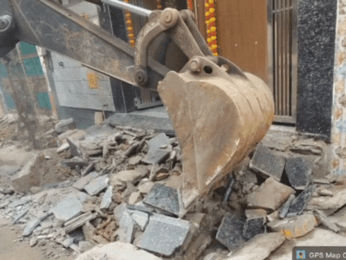 Bulldozer runs on the ramp outside the house