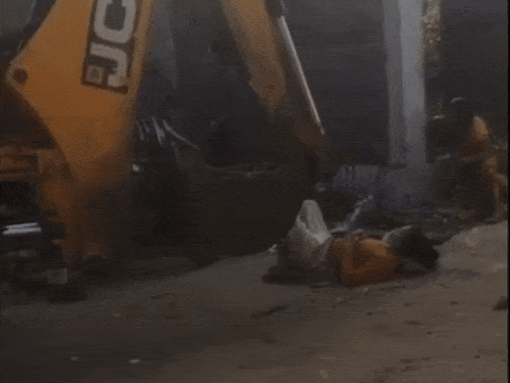 Fearing encroachment removal, the elderly man lay down in front of the JCB.