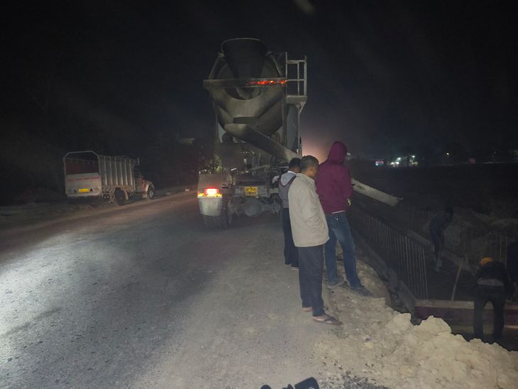 Construction of drain at Sanai intersection, half the road occupied.