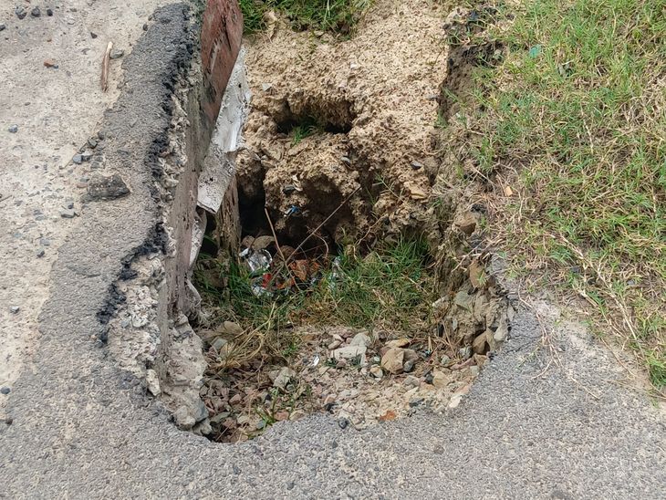 Rain cut pits on the road near the bridge