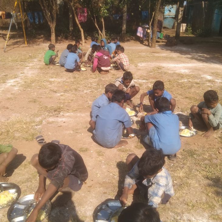 Tribal Ashram: Children sitting at tables smoking beedis openly, with ...