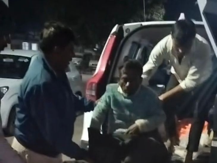 Two people sitting on the roadside were hit by a bike.