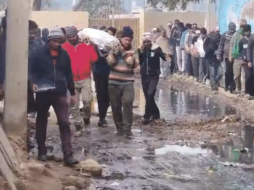 The funeral procession of a young man passed through a muddy street