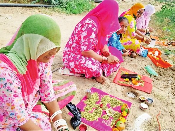 On the full moon day, women performed rituals on the banks of the pond.