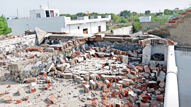 A 20-foot-high wall collapsed, causing cracks in the walls and slabs.