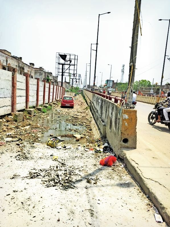Heaps of garbage on the flyover's service lane, causing trouble due to ...