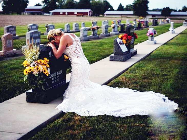 Grieving bride in wedding dress sobs on grave of dead fiance ...