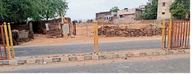 Seven iron railings installed on the divider near Khodiyar Char Rasta ...