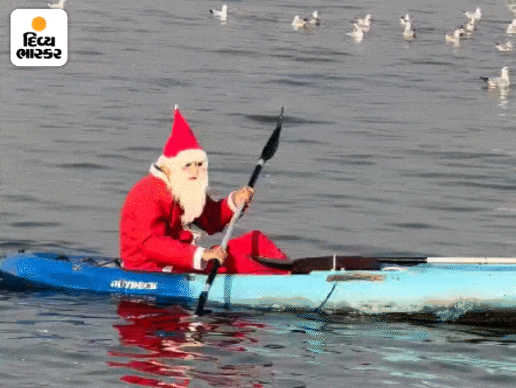 Santa Claus driving a kayak with exotic birds in the Tapi River in ...