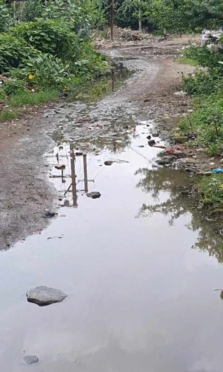 People face great hardship as rainwater floods the road in Bilkha