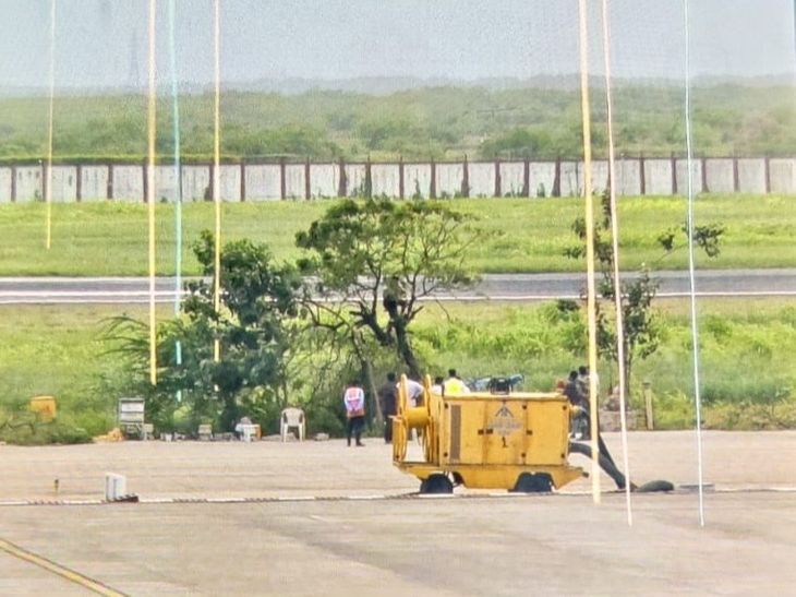 Empty temple structure and tree obstructing parallel taxi track of ...