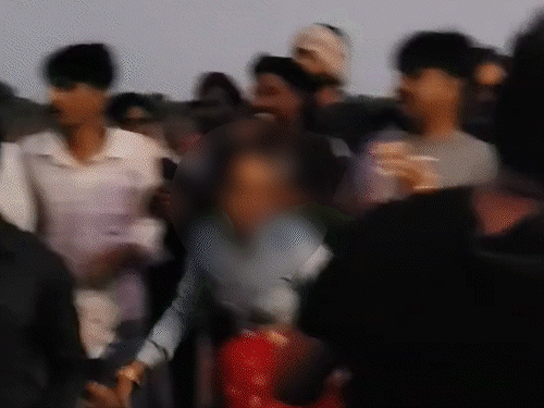 woman thrashes youth with slipper on road outrage after bus ...