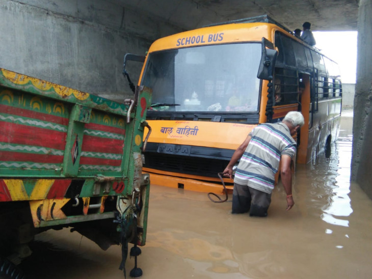 School bus stuck in deep water under railway bridge, children rescued ...