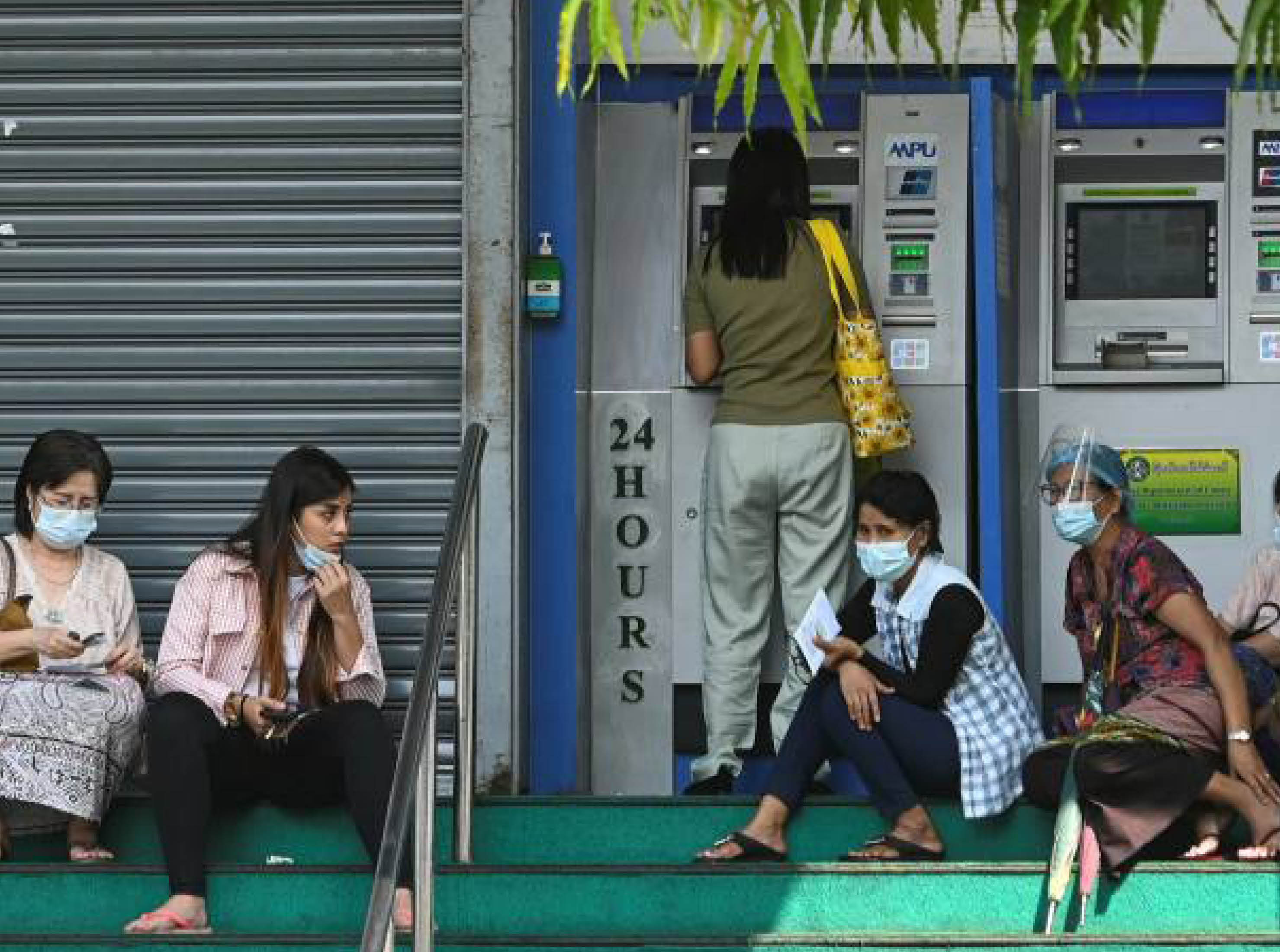 ATMs in Myanmar withdraw money after standing in line for empty hours ...
