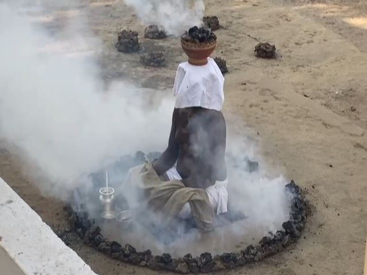 By keeping the burning khappar on the head and sitting in the midst of ...