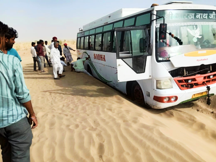 Passengers of the bus pushed the bus out of the sand with a struggle of ...