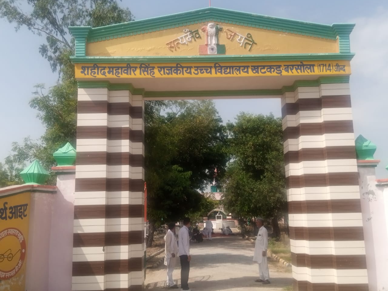 Villagers sit on dharna outside the village Khatkar school in Jind ...