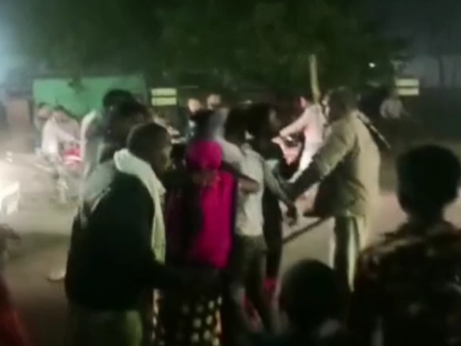 alcoholics fight on the middle of the road, woman showers slippers ...