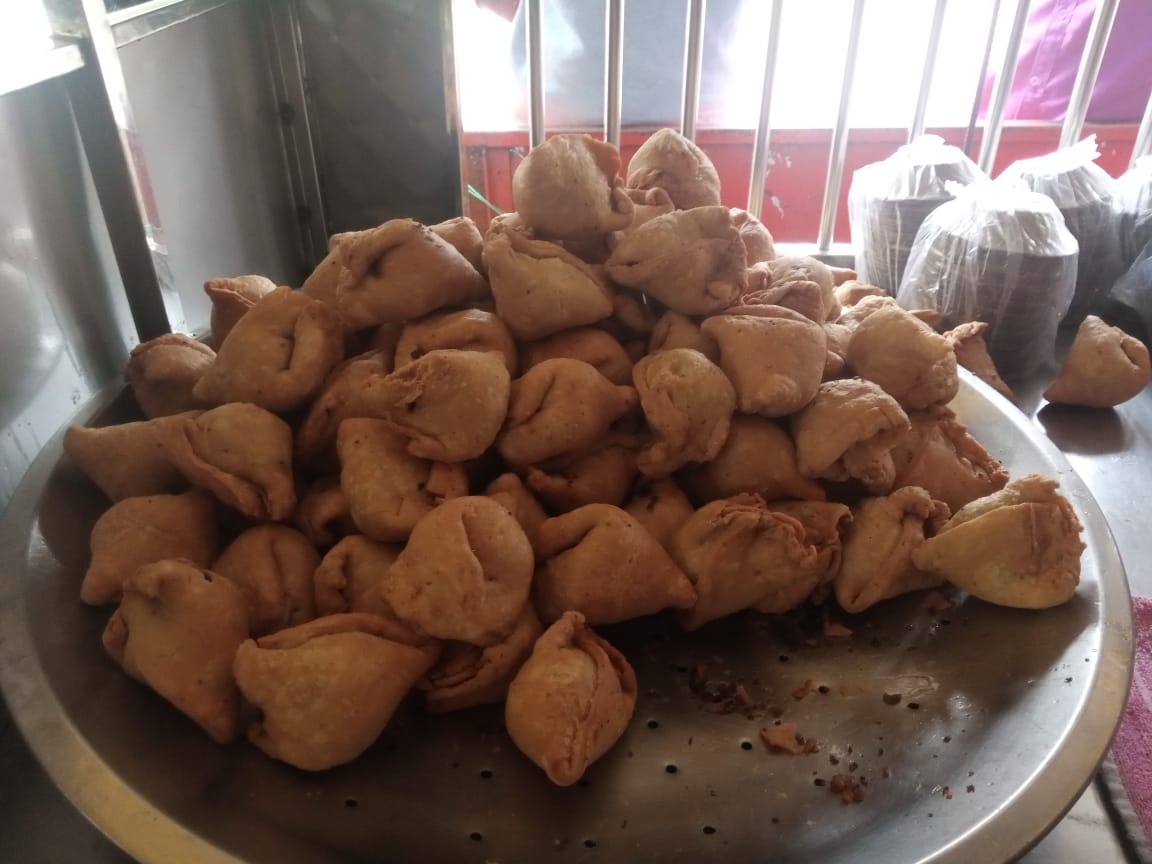 Hundreds of people are busy at the shop, thousands of samosas are sold ...