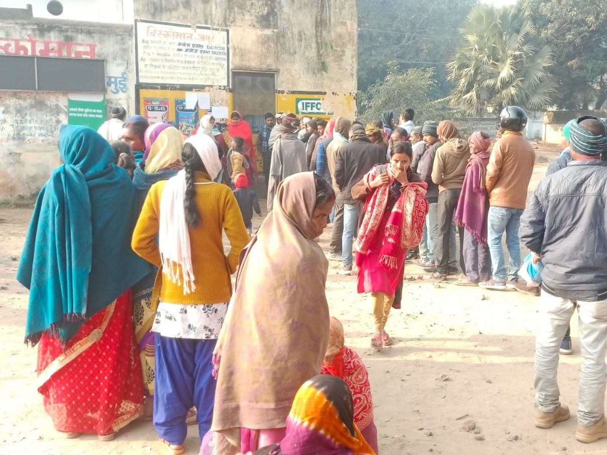Woman standing in line with small children, ruckus in Biscoman Bhavan ...