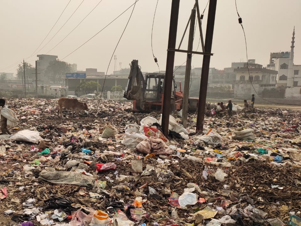 Garbage being thrown on the roadside, polluting the air; townspeople ...