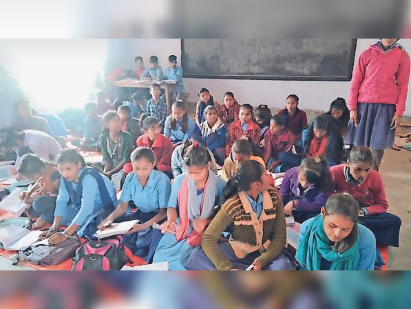 Seventh and eighth grade students study sitting on the ground in UMVI ...