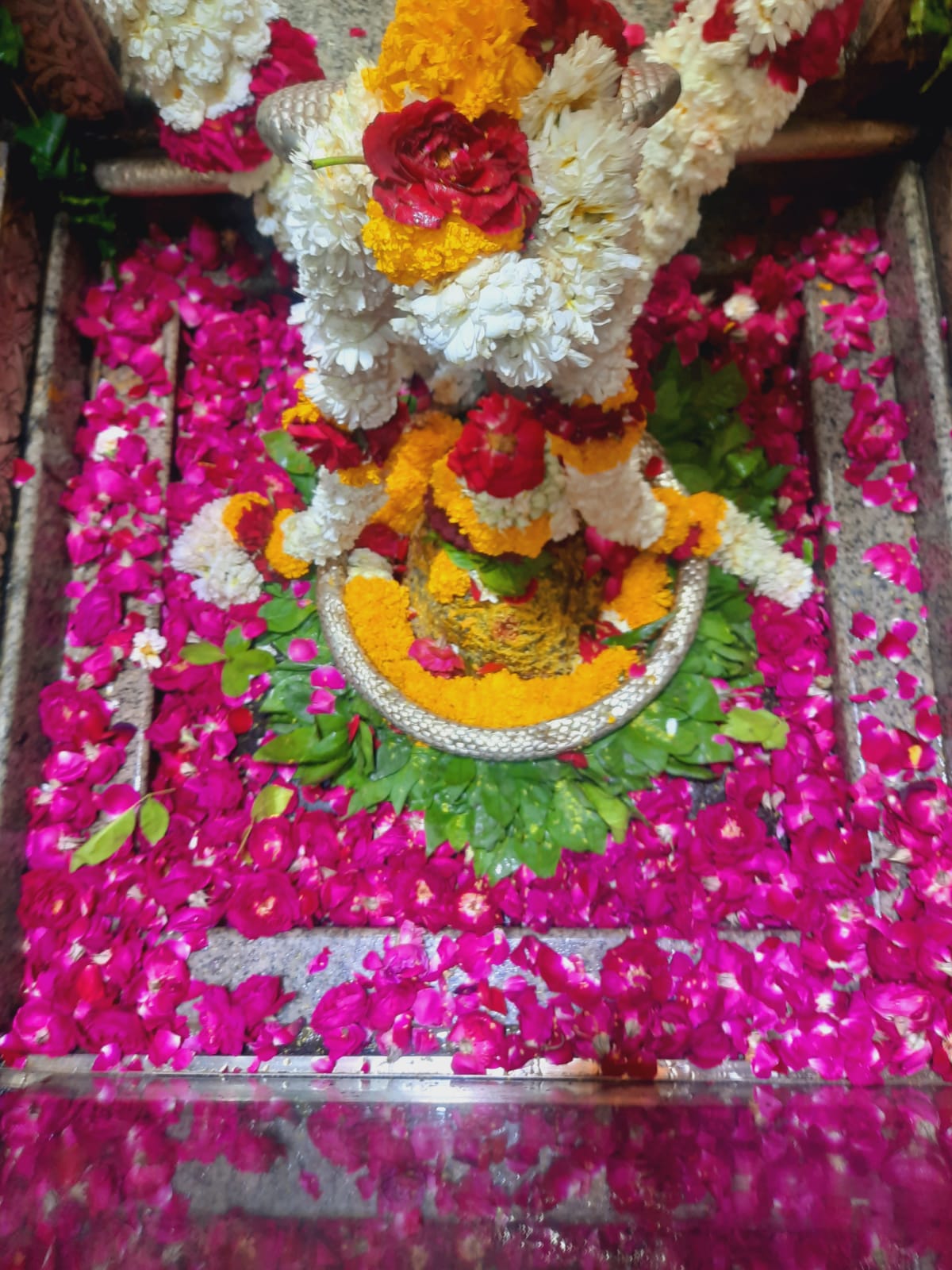 Lord Omkar and the court decorated with flowers in Mangala Aarti, see ...