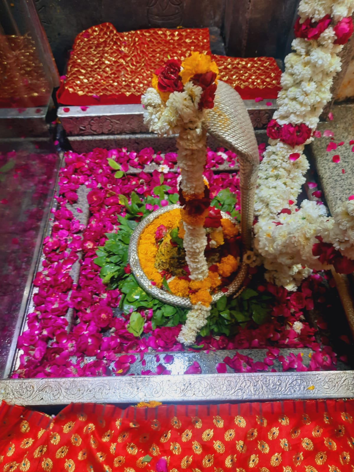Lord Omkar and the court decorated with flowers in Mangala Aarti, see ...