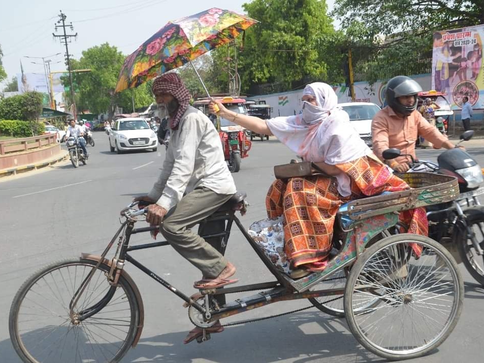 Sitting behind the rickshaw driver, she put an umbrella in the hot sun, DM said - heart touching ...