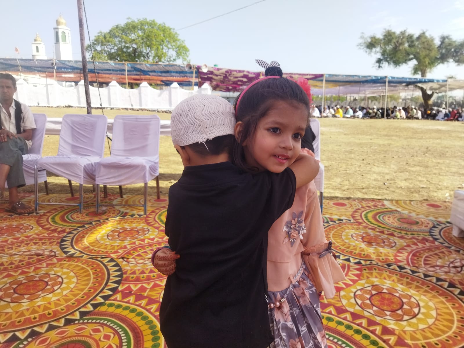 Muslim brothers greet each other by hugging each other after offering ...