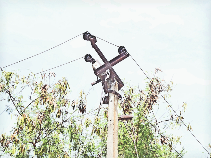 Broken pole hangs in the air with the help of high tension line for ...