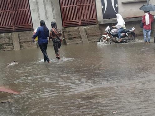 A respite from the sweltering heat; drenched people on rooftops ...