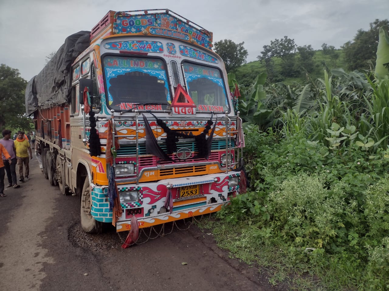 Truck stuck in dug road to lay cables, pulled out with the help of four ...
