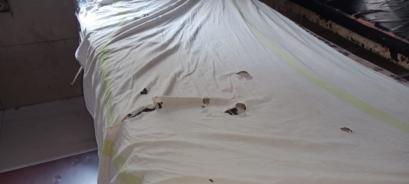 Unwashed sheets on the beds, torn mattresses, only one cooler in the ...