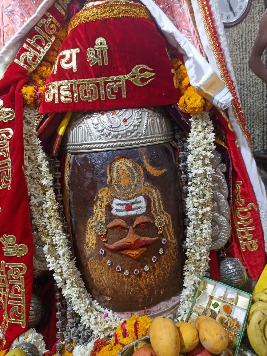 Lord Mahakal is adorned by offering a garland of Rudraksha along with ...