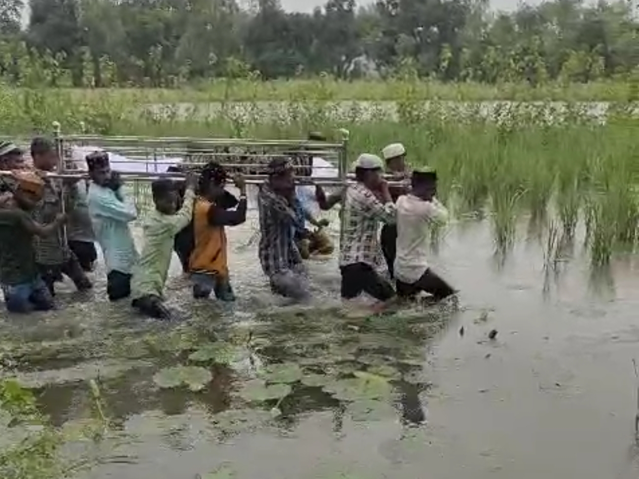 People carrying the funeral procession passed through five feet of water