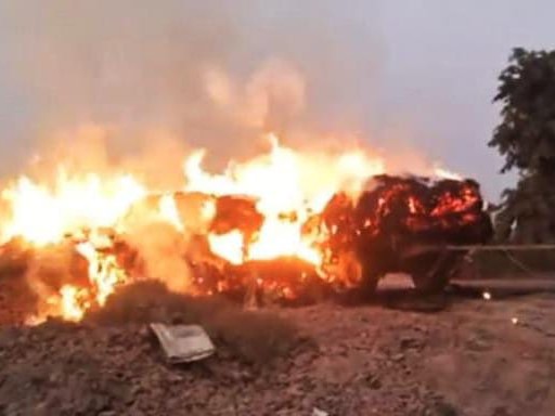 A tractor-trolley loaded with stubble caught fire