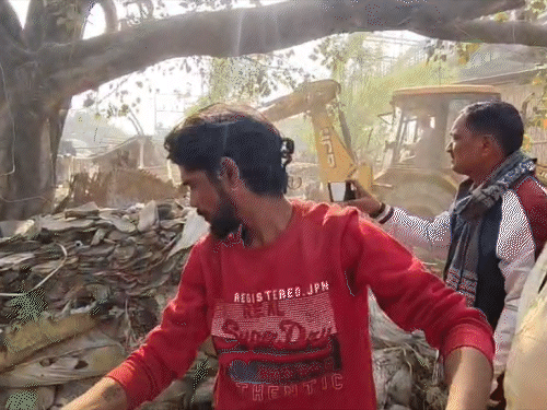 Angry over bulldozer action, man cuts his hair on camera
