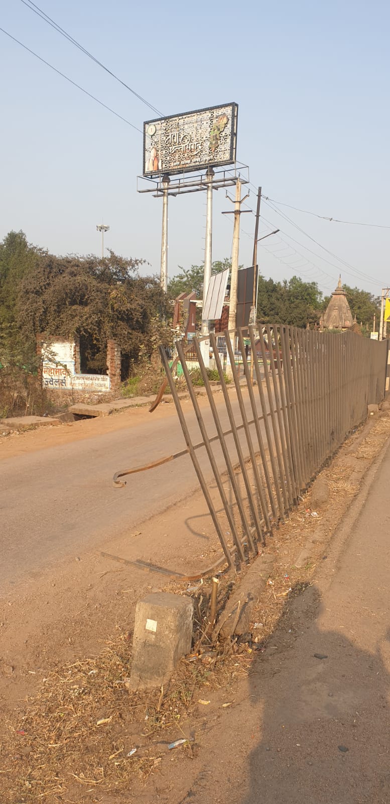 Kaivalya Dham Road; rods protruding from the divider railing